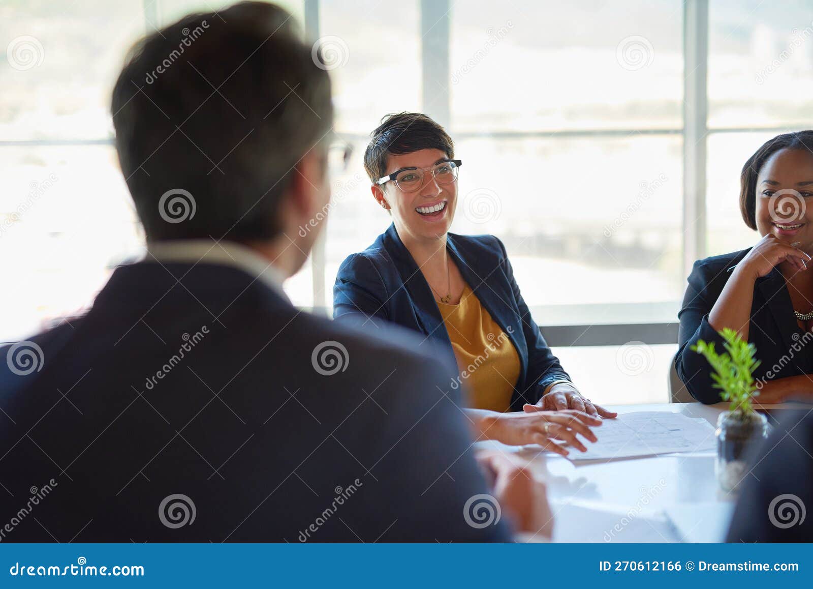 Getting an Update in the Boardroom. Four Corporate Businesspeople ...