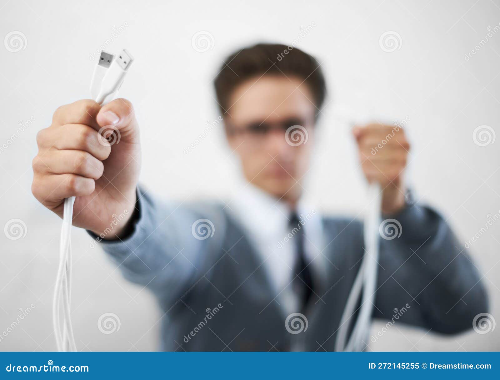 Getting Wired Up. a Young Nerdy Guy Holding Usb Cables Toward the ...