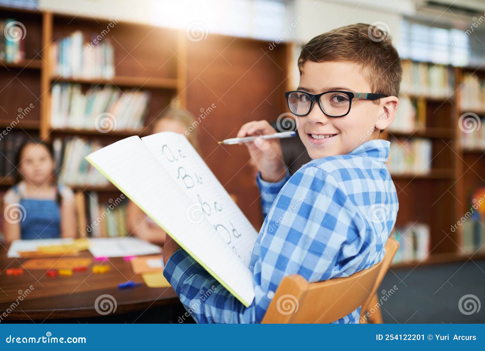 Getting into the Work. Portrait of a Cheerful Young Boy Doing School ...