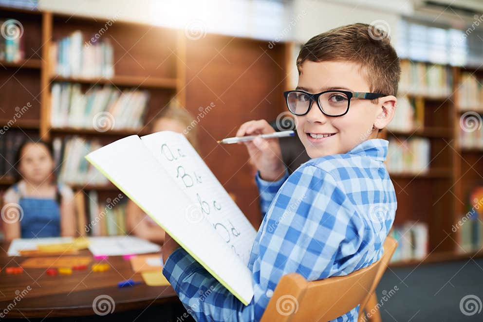 Getting into the Work. Portrait of a Cheerful Young Boy Doing School ...