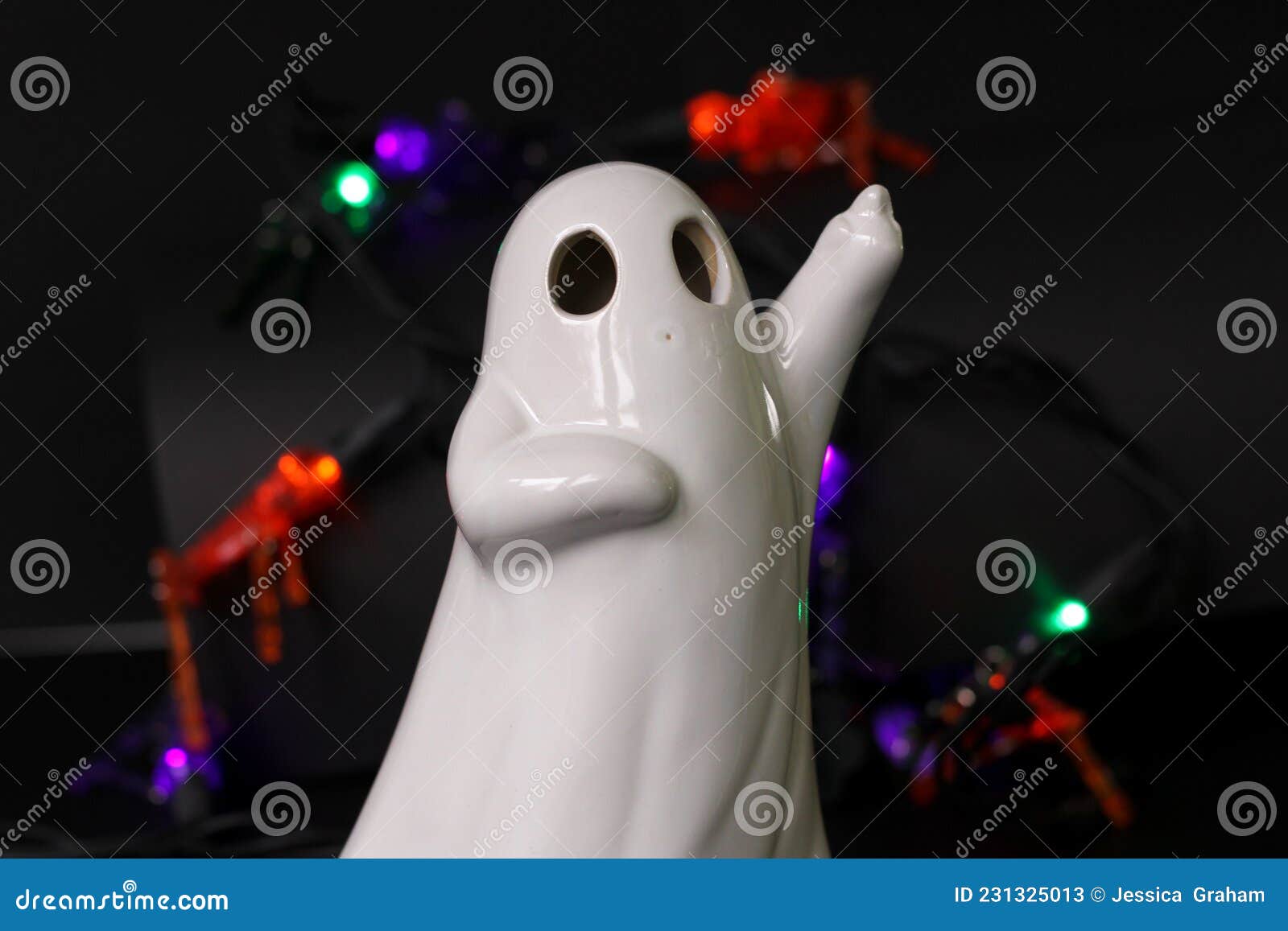 Ghost Figurine with Halloween Lights in the Back Stock Image - Image of ...