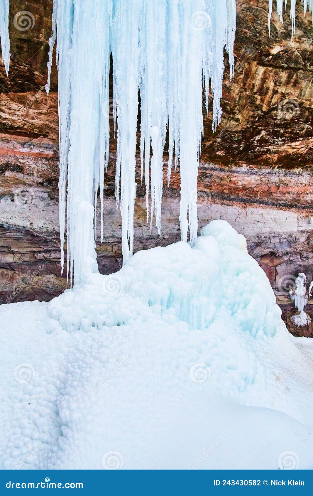 Giant Icicles on Cliffs Forming Pile of Ice Lumps Stock Photo - Image ...