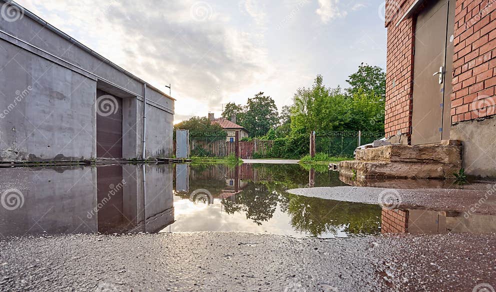 Giant puddle in the yard stock photo. Image of plash - 259369884
