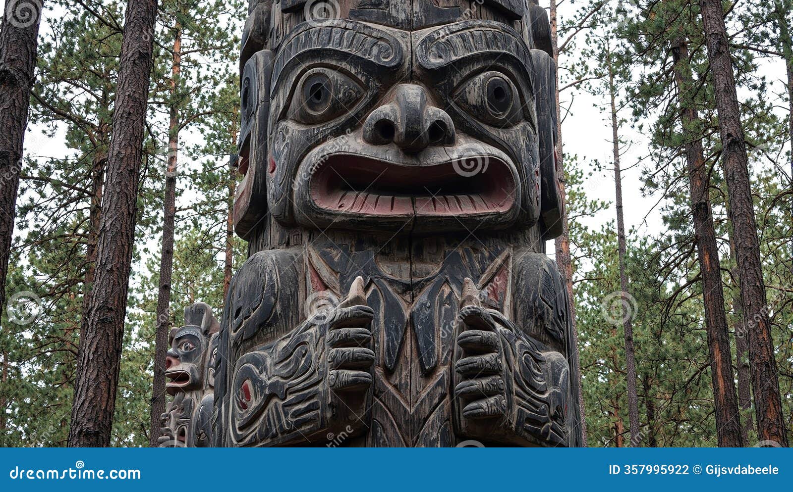 Giant Totem Pole with Bear and Fox Carvings Blending into Pine Forest ...