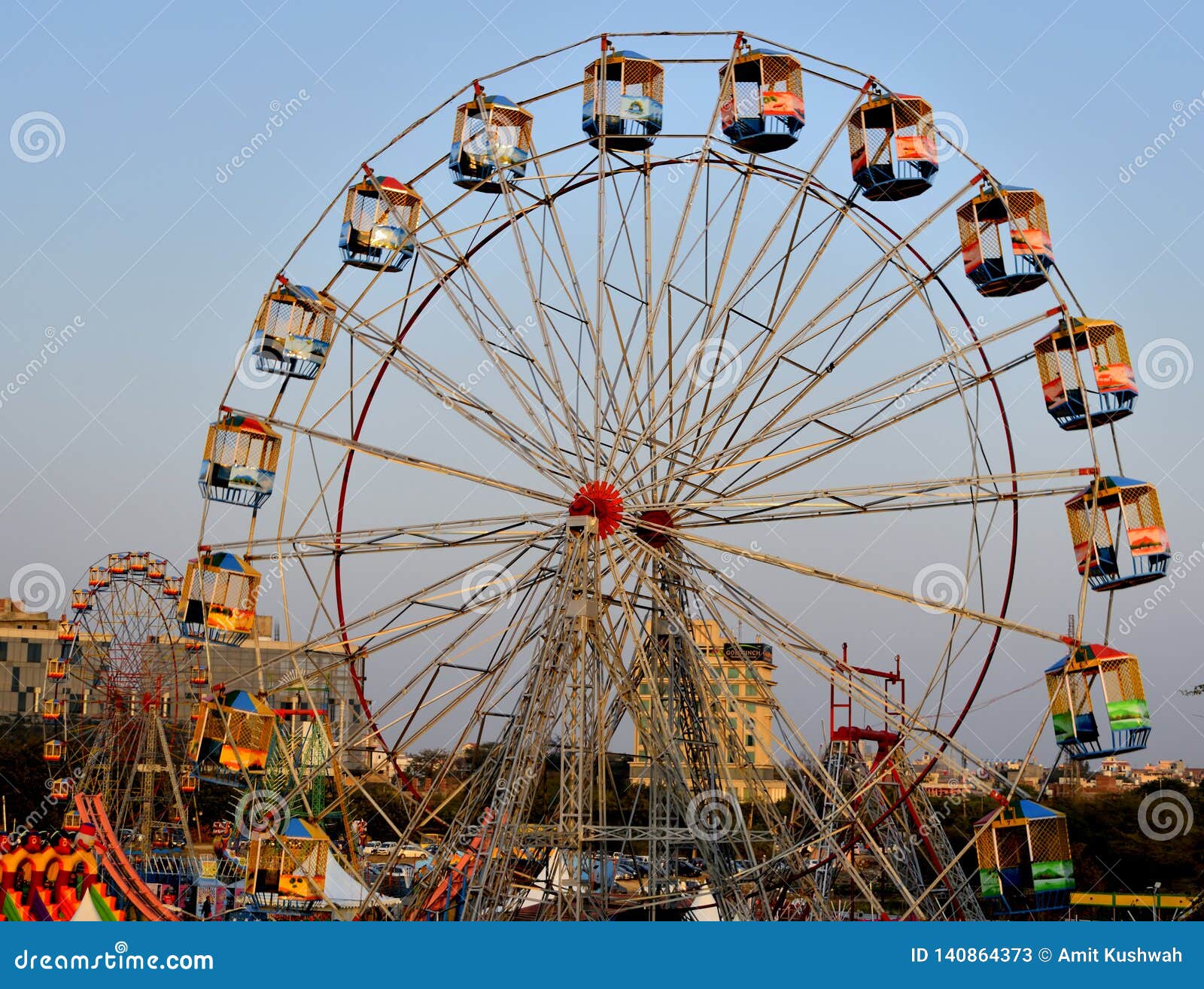 A giant wheel and rides editorial stock photo. Image of family - 140864373