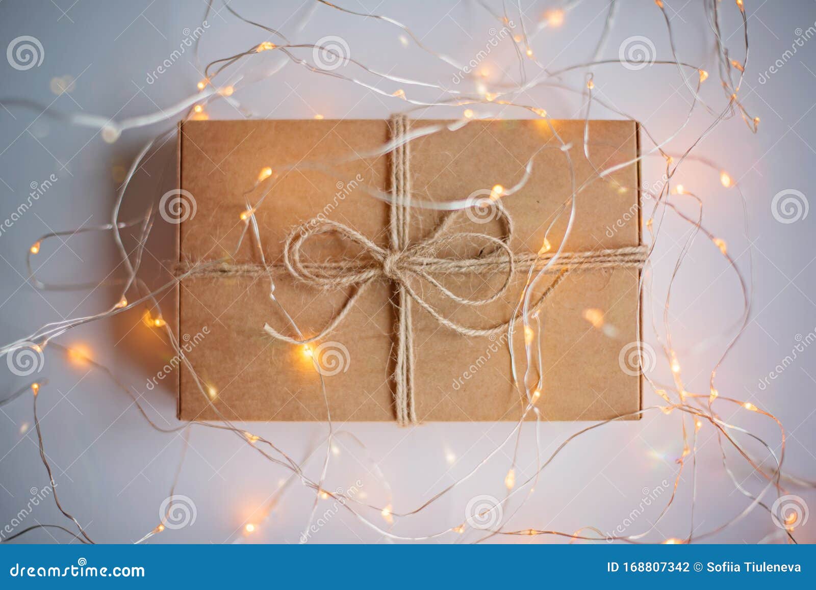 Gift Box of Craft Cardboard in a Luminous Garland. Stock Photo - Image ...