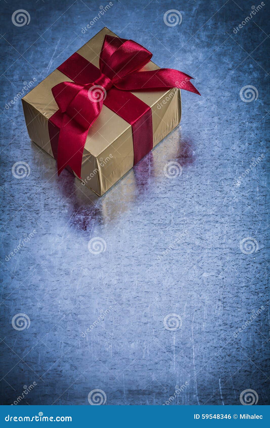 Gift Box Wrapped in Shining Golden Paper on Metallic Surface Stock ...