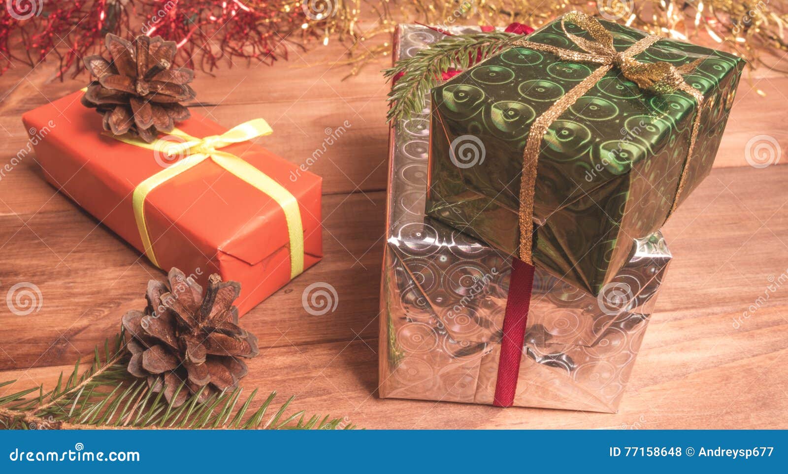 Gift Boxes among the Christmas Tinsel and Cones Stock Photo - Image of ...