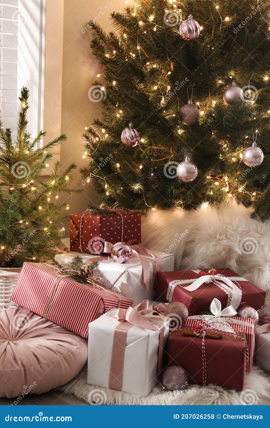 Gift Boxes Under Small and Big Christmas Trees Indoors Stock Photo ...