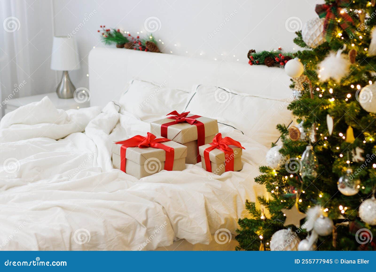 Gify Boxes on the Bed in Decorated Bedroom with Christmas Tree Stock ...