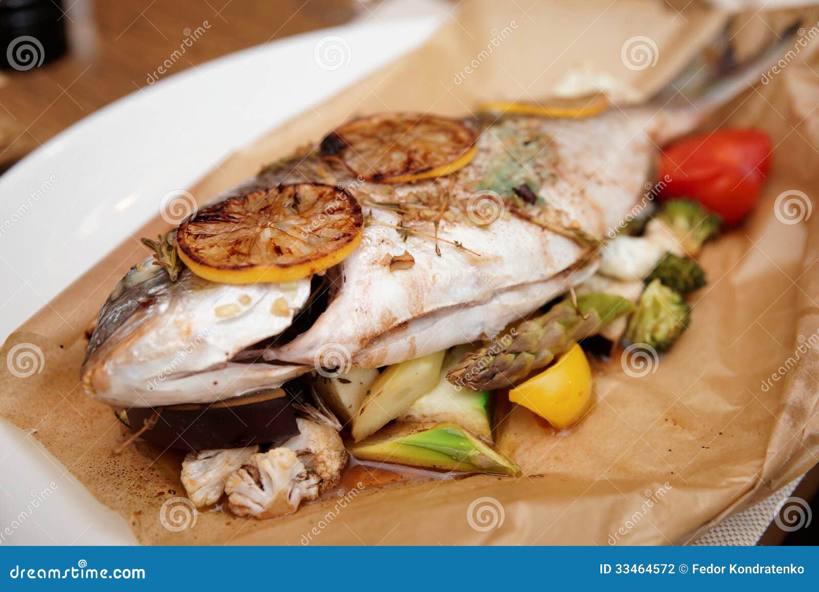Gilt-head Bream Roasted in Paper with Vegetables Stock Photo - Image of ...