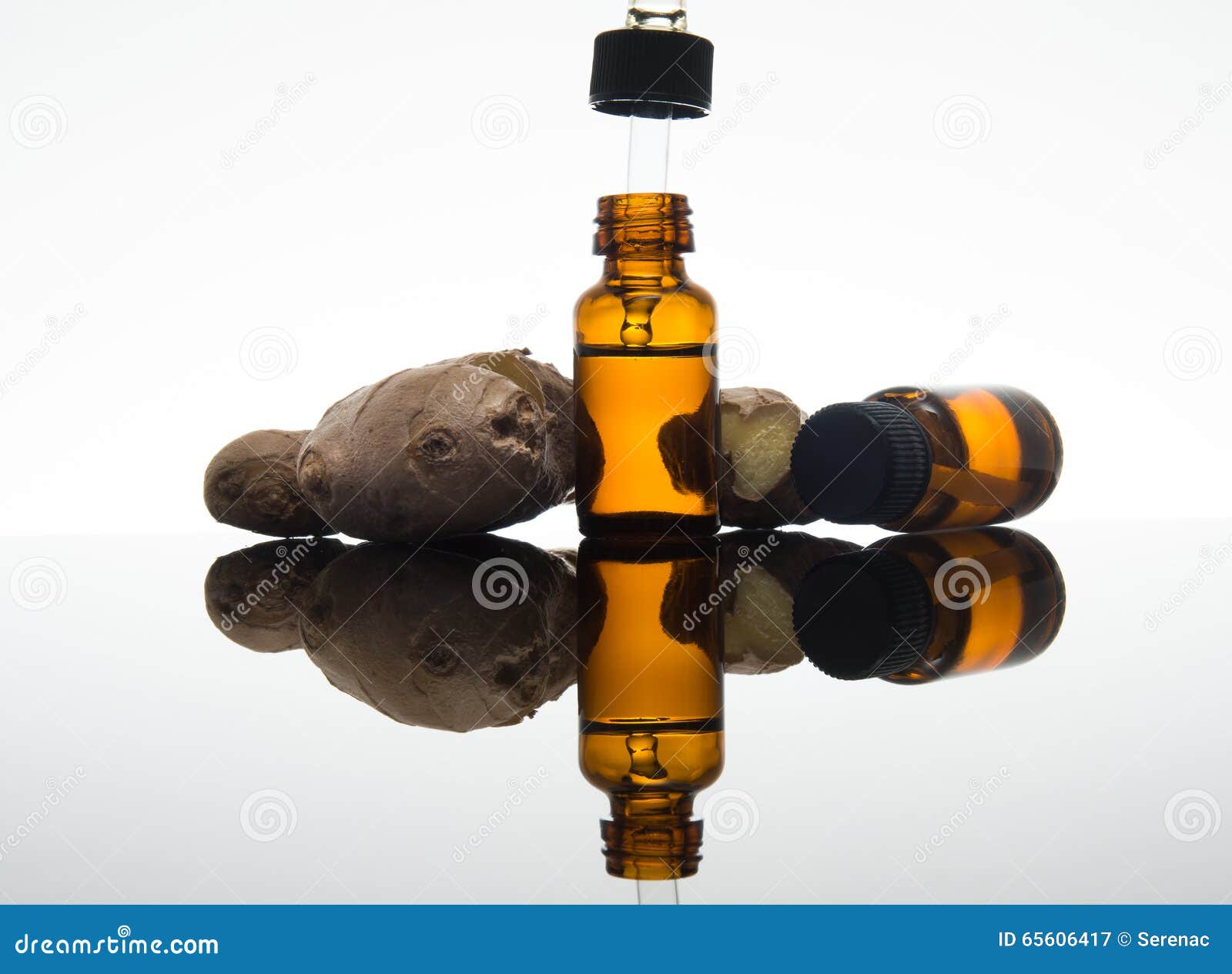 Ginger Essential Oil in Amber Bottle with Ginger Root and Dropper Stock ...