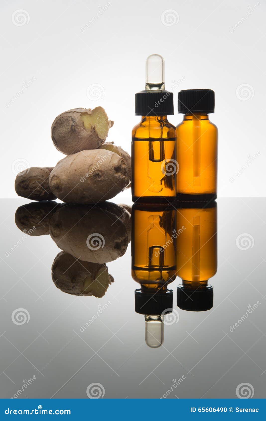 Ginger Essential Oil in Amber Bottle with Ginger Root and Dropper Stock ...