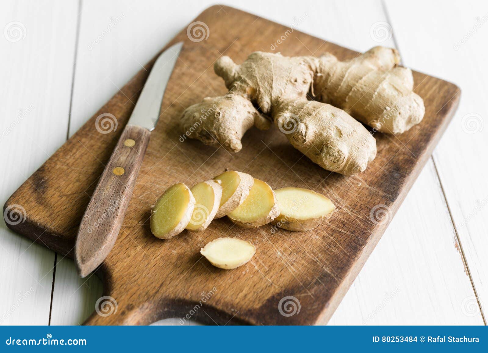 Ginger Root Sliced on Old Cutting Board and White Table Stock Photo ...