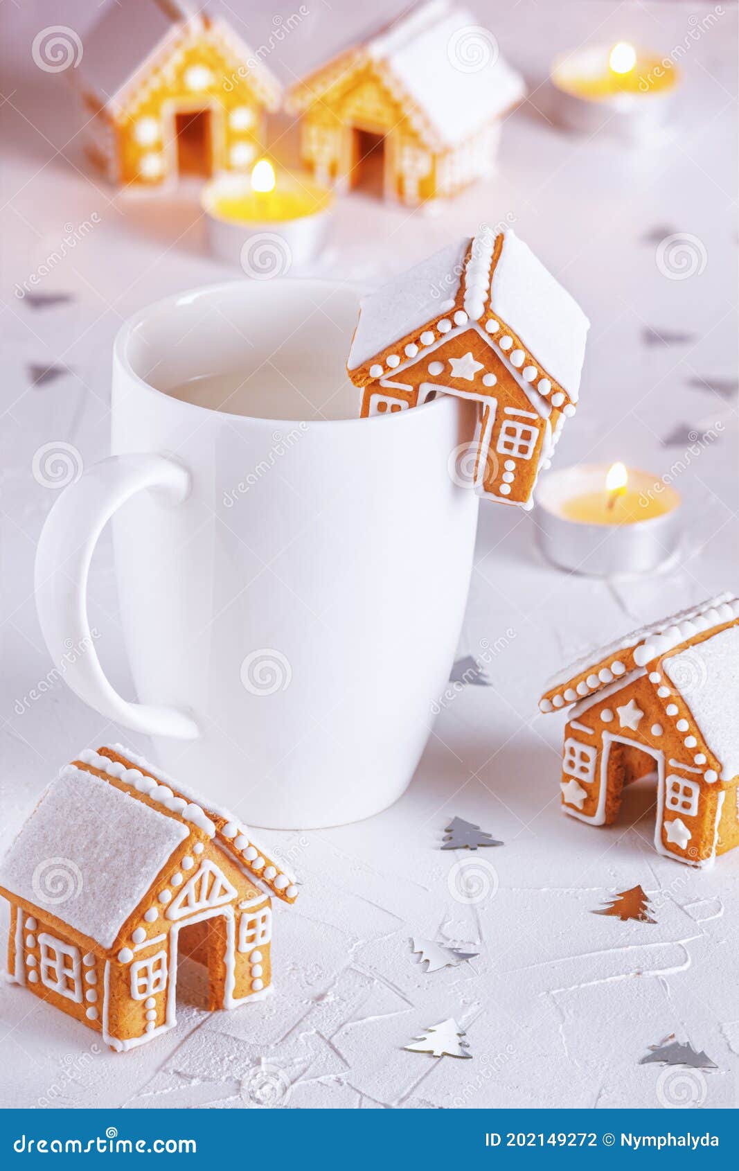 Gingerbread Huts and a Cup of Milk on a White Textured Surface with ...