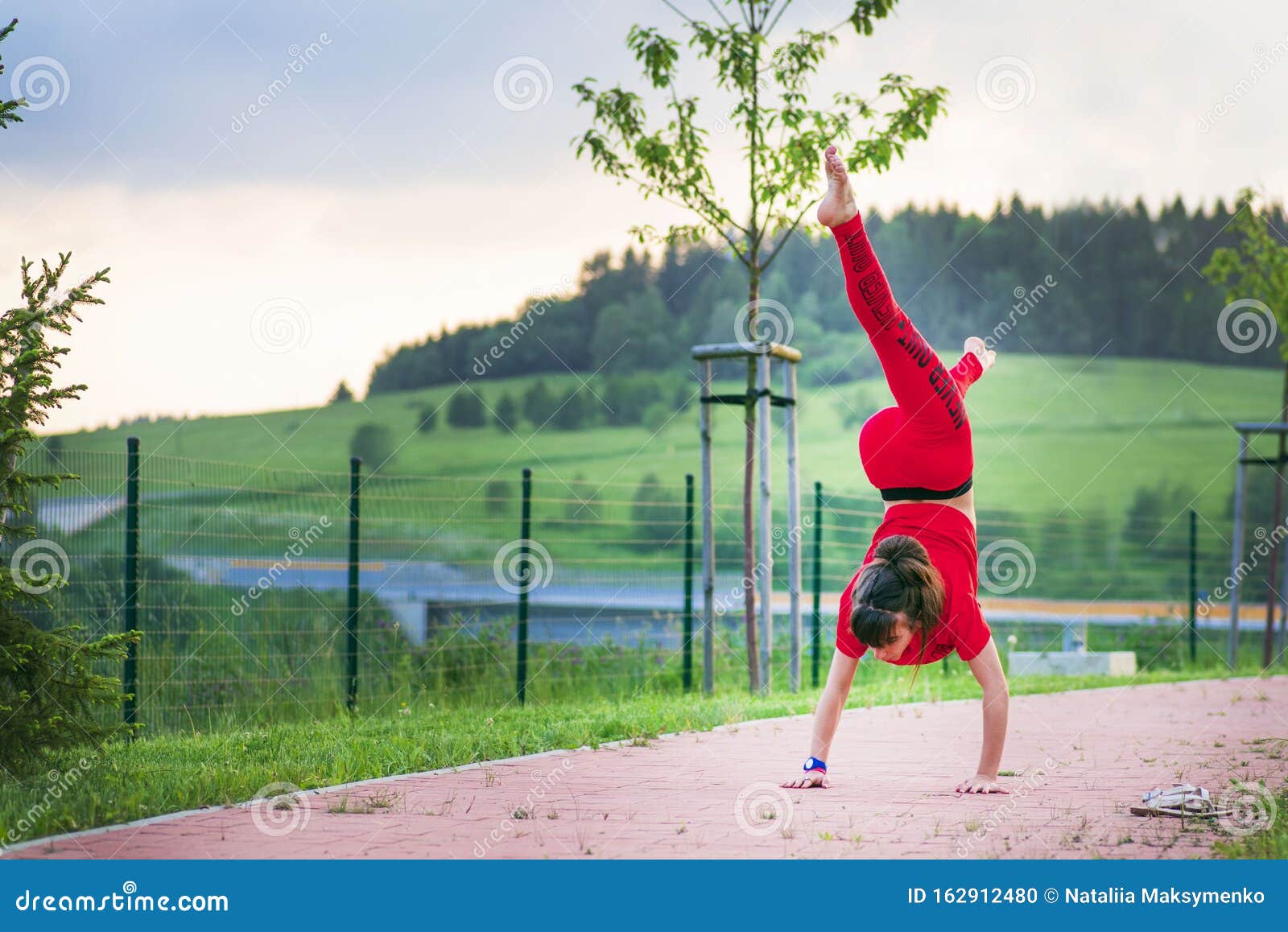 Girl Acrobatics on the Street.a Girl Does Acrobatic Stunts on the ...