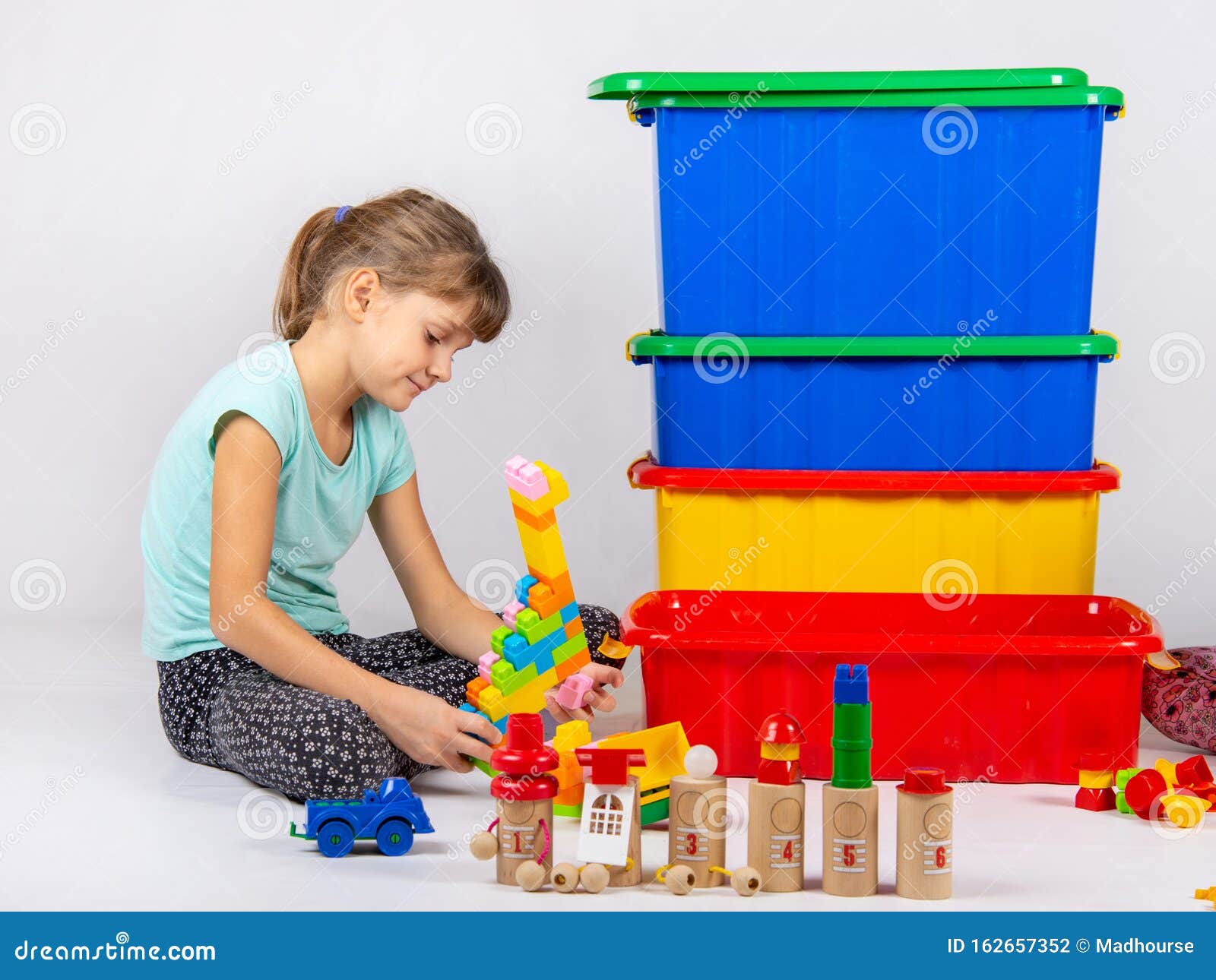 Girl alone plays toys stock photo. Image of girl, storage - 162657352