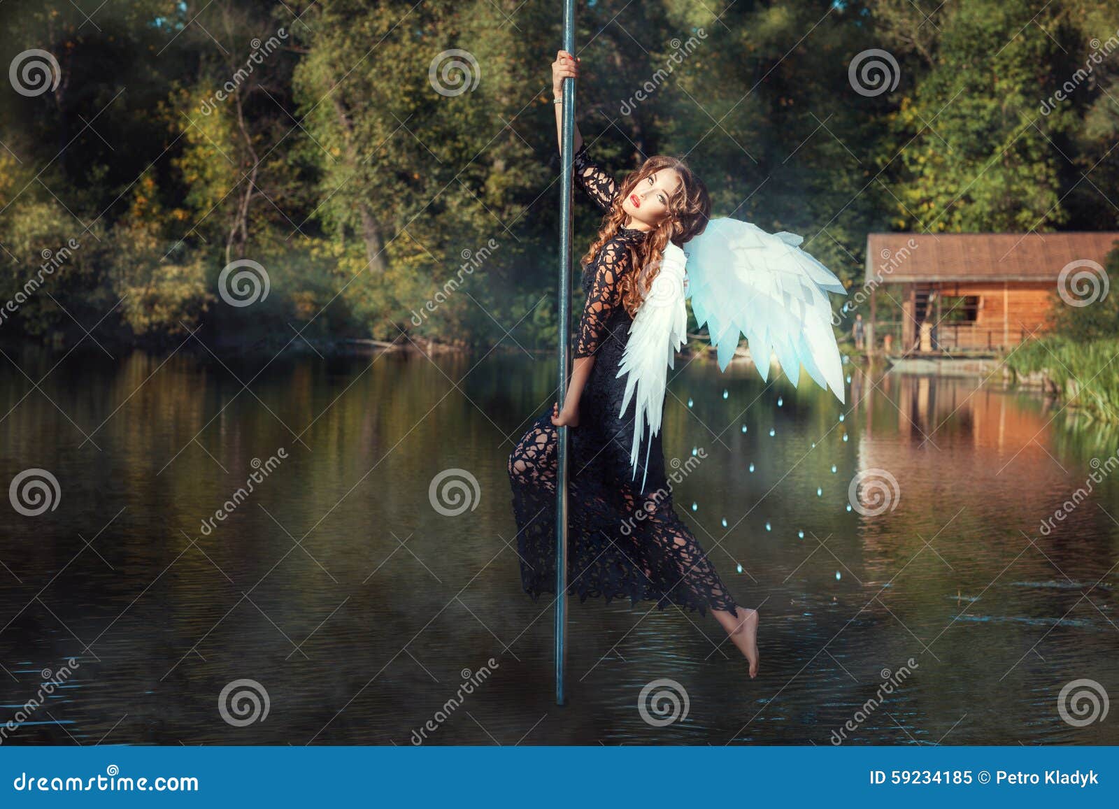 Girl with Angel Wings Dancing on the Pole. Stock Image - Image of ...