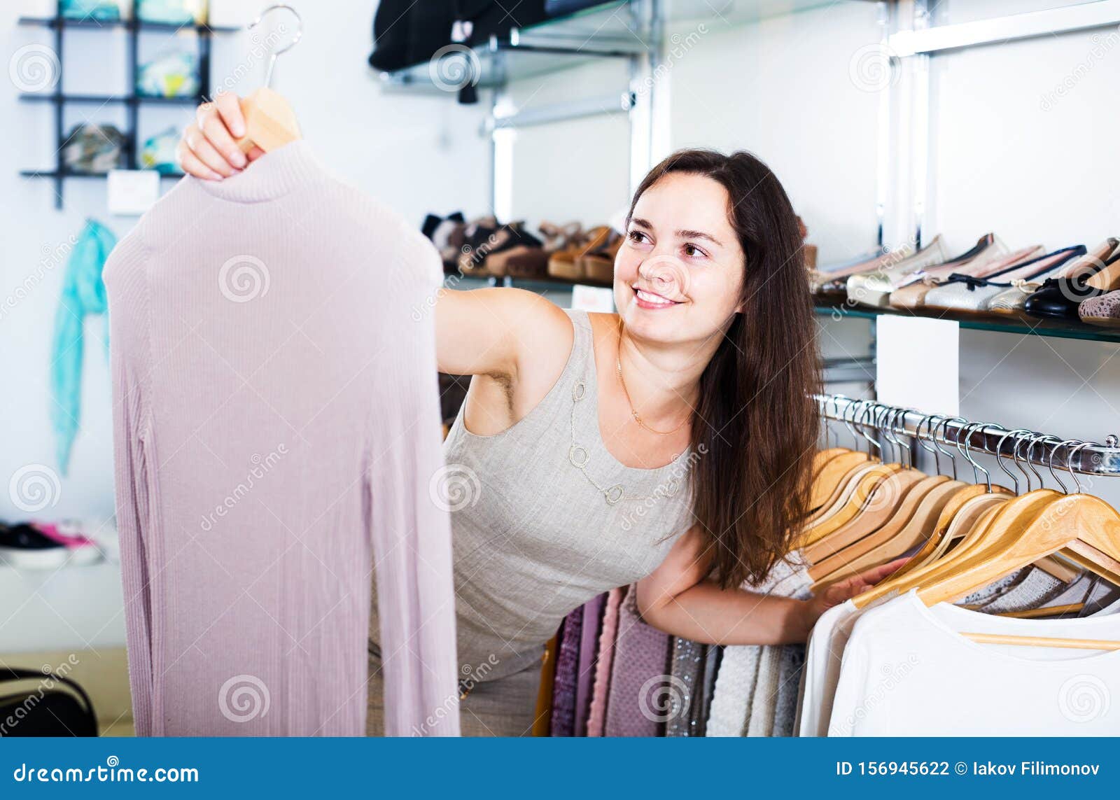 Girl in apparel store stock photo. Image of positive - 156945622