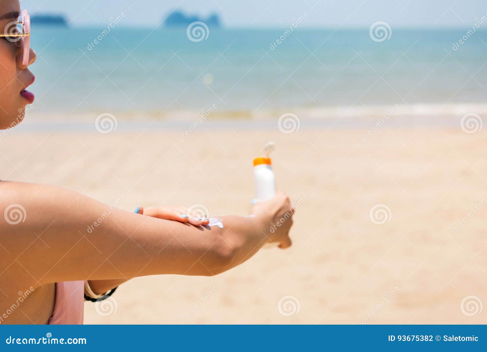 Girl Applying Sun Lotion on the Beach Stock Photo - Image of spread ...