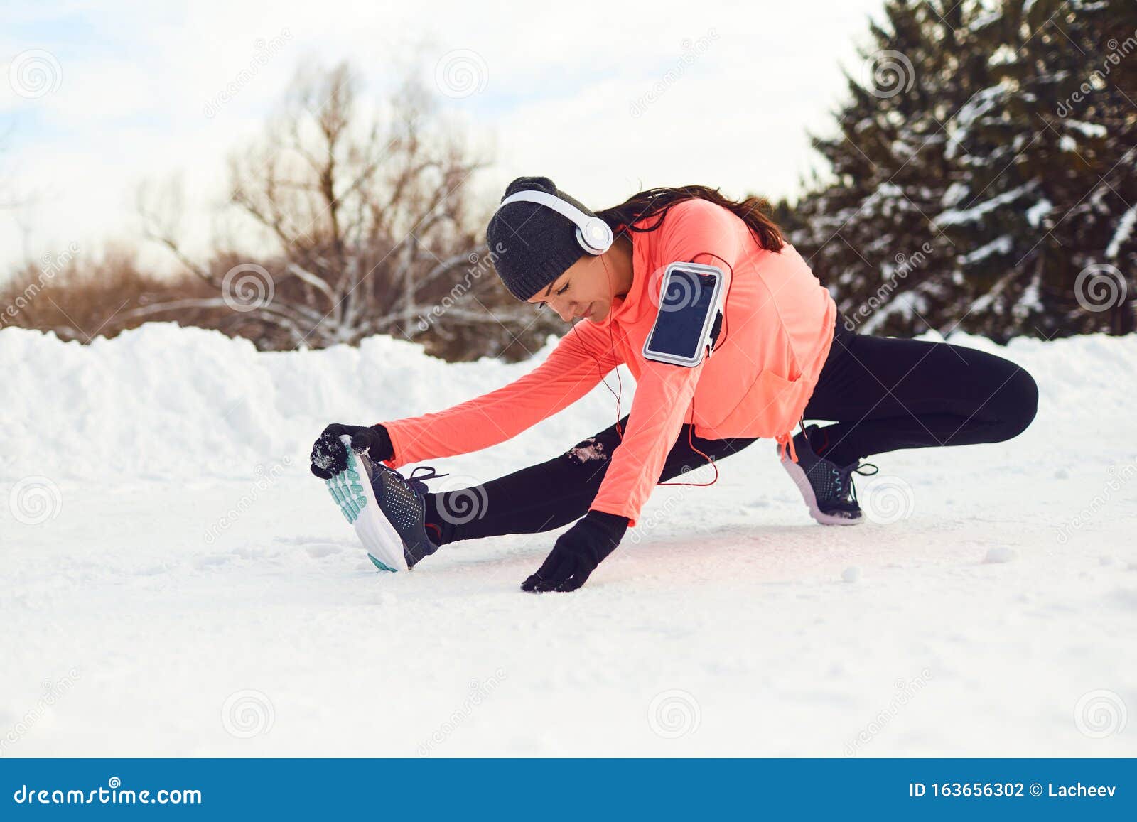 Girl Athlete Does Stretching Legs on the Snow in Winter. Stock Photo ...