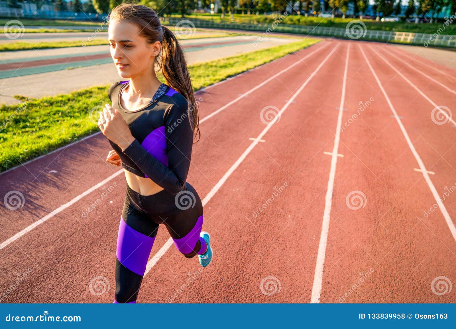 Girl Athlete Runs on the Stadium at Sunset Stock Photo - Image of ...
