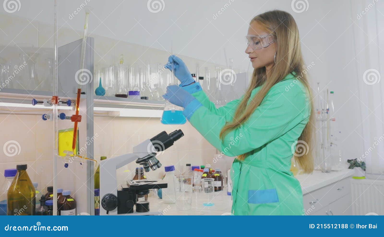 Girl with a Beaker in Hand Smiles Looking into the Camera. Girl in ...