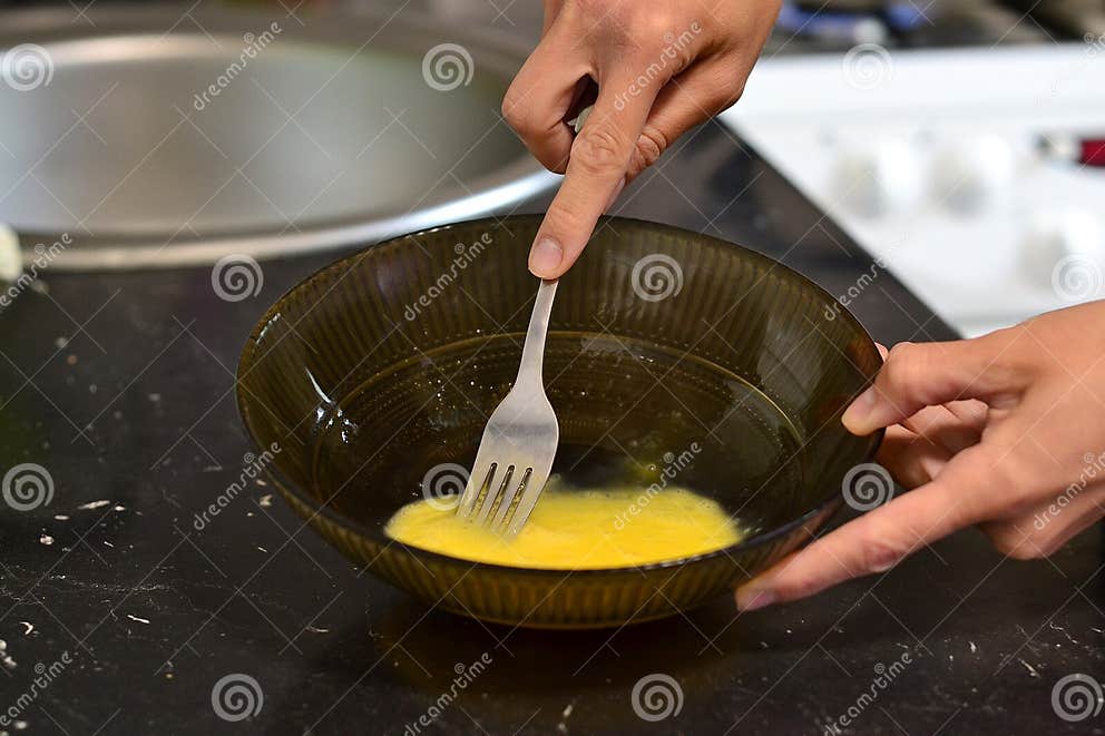 The Girl is Beating an Egg for Pancakes in a Plate Stock Photo - Image ...