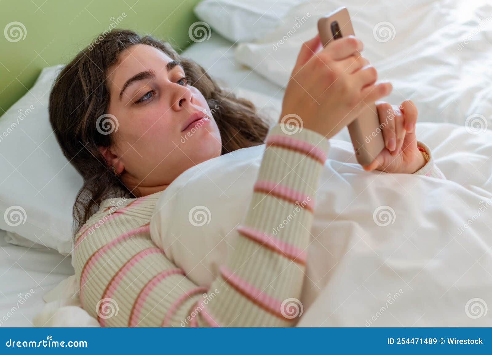 Girl in a Bed Checking Her Phone Stock Image - Image of sleep, rest ...