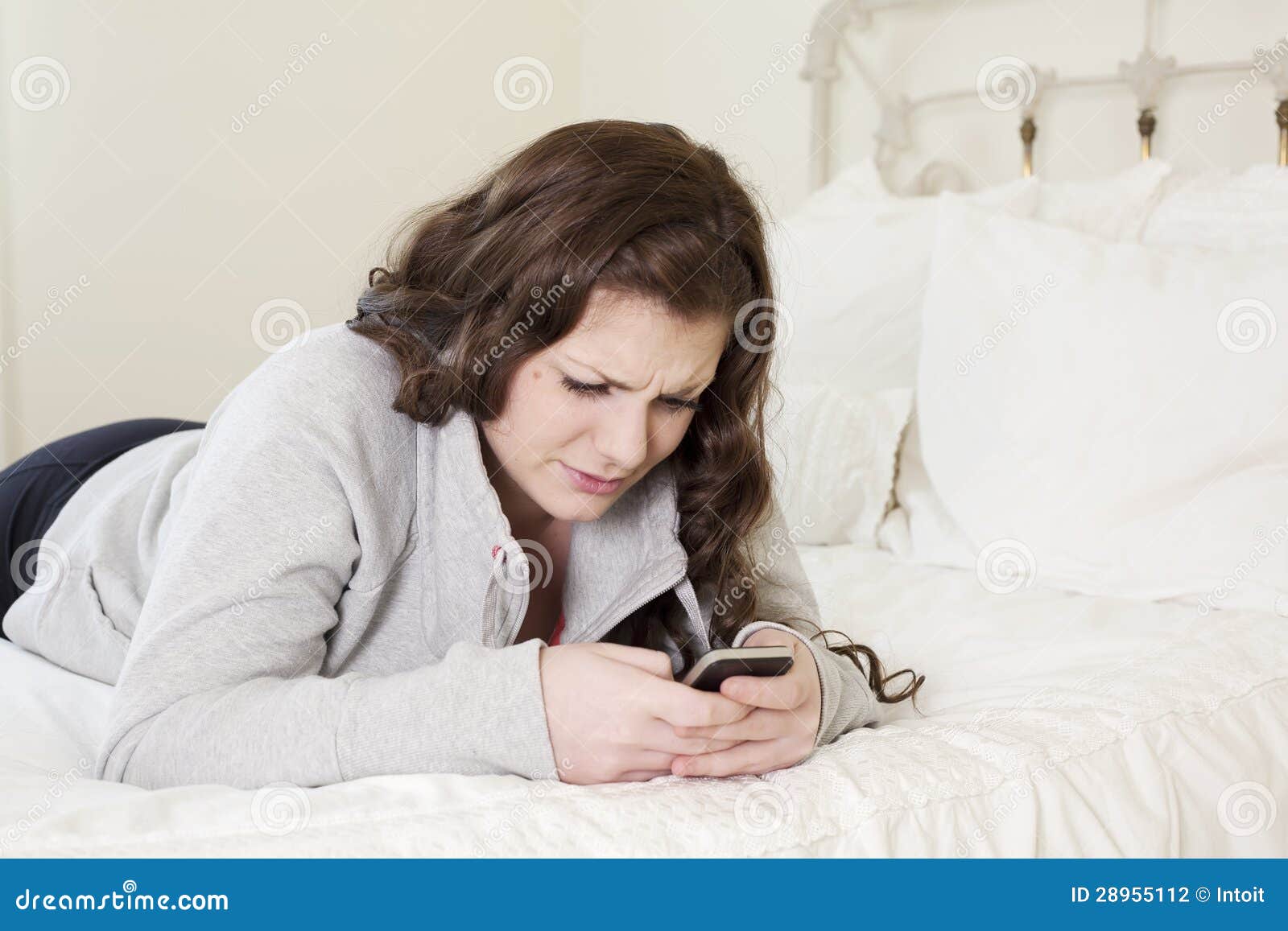 Girl on Bed Texting stock photo. Image of news, communicate - 28955112
