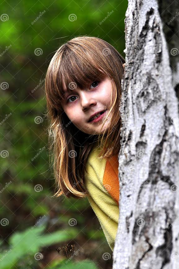 Girl behind a tree stock photo. Image of outdoors, expression - 15495998