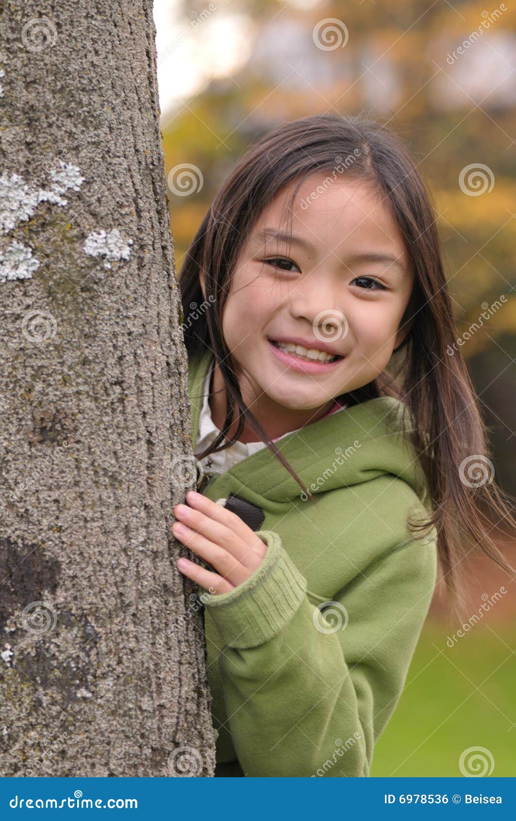Girl behind the tree stock photo. Image of smile, oriental - 6978536