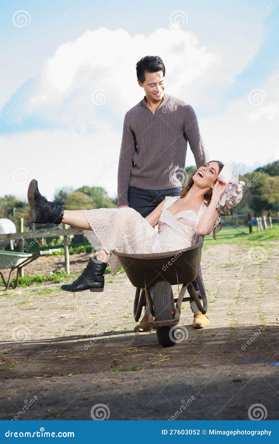 Girl Being Pushed in Wheelbarrow by Man Stock Photo - Image of ...