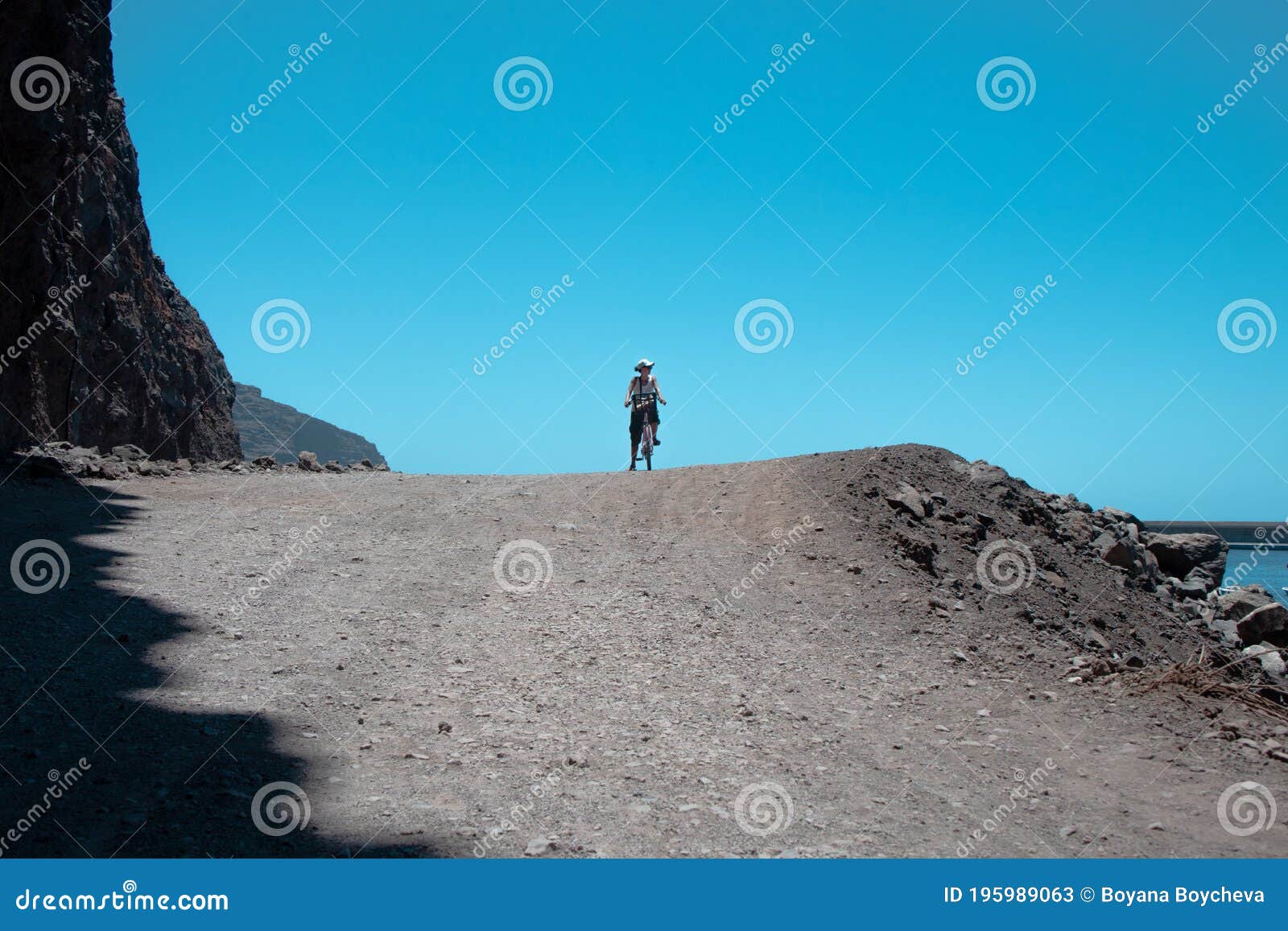 A Girl on a Bicycle on Her Way To a Rock Stock Image - Image of ocean ...