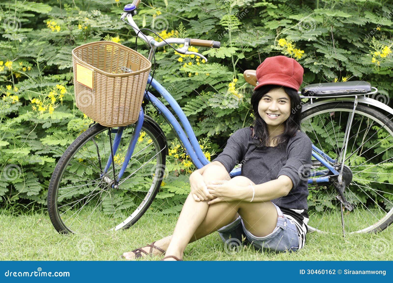 Girl with a Bicycle Rests on a Grass Stock Photo - Image of green ...