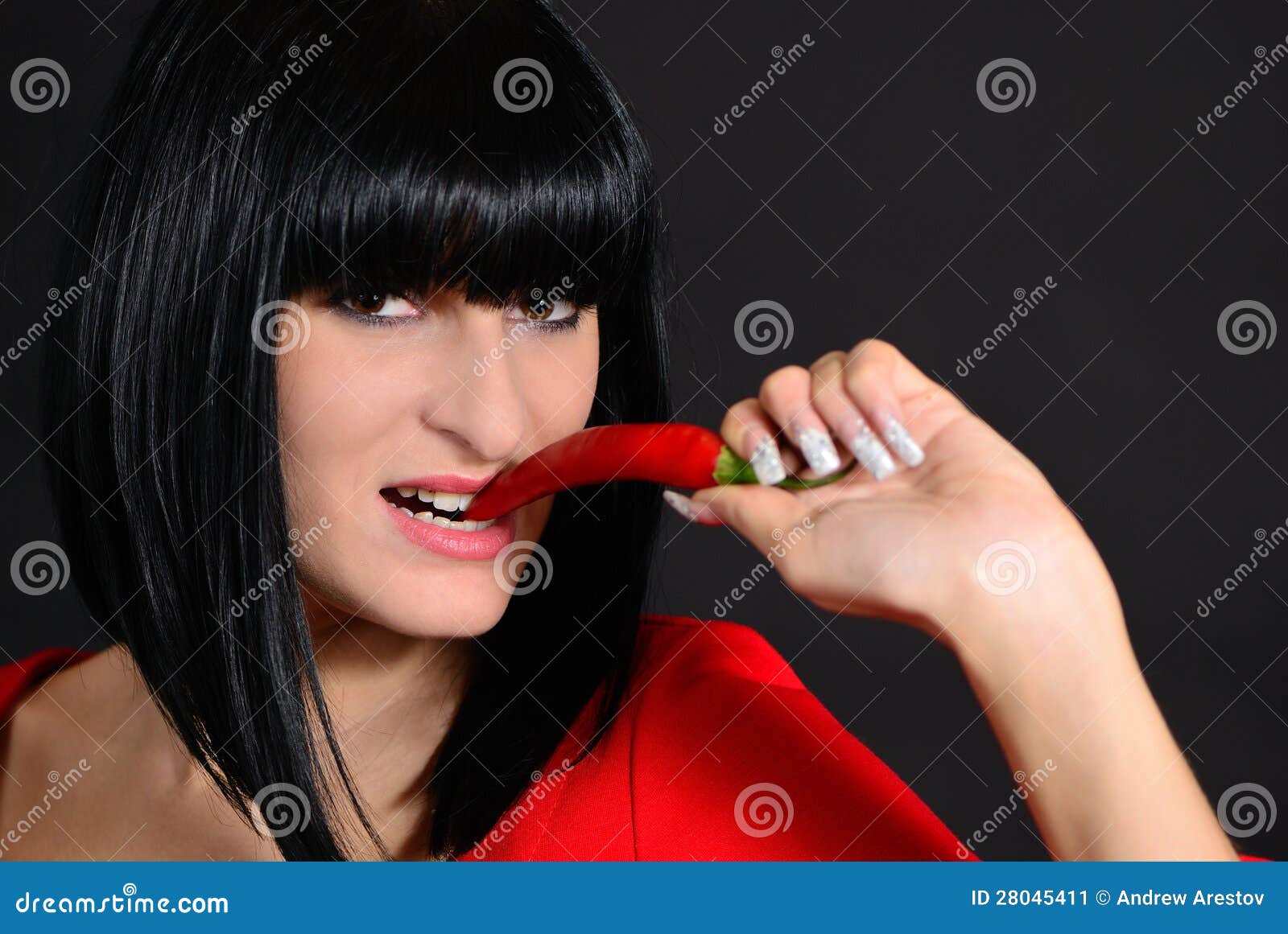The girl bites hot pepper stock image. Image of capsicum - 28045411