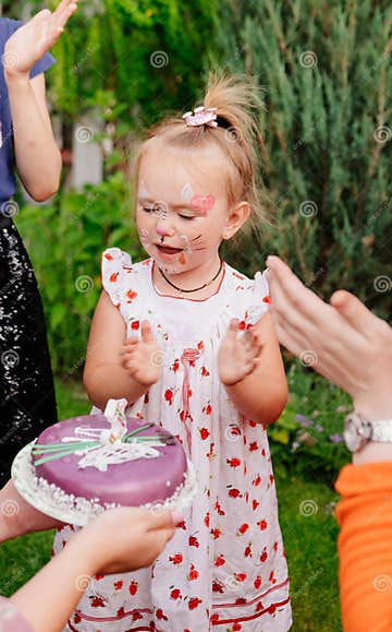 Girl Blows Out Candle On Birthday Cake On Lawn Stock Image Image Of