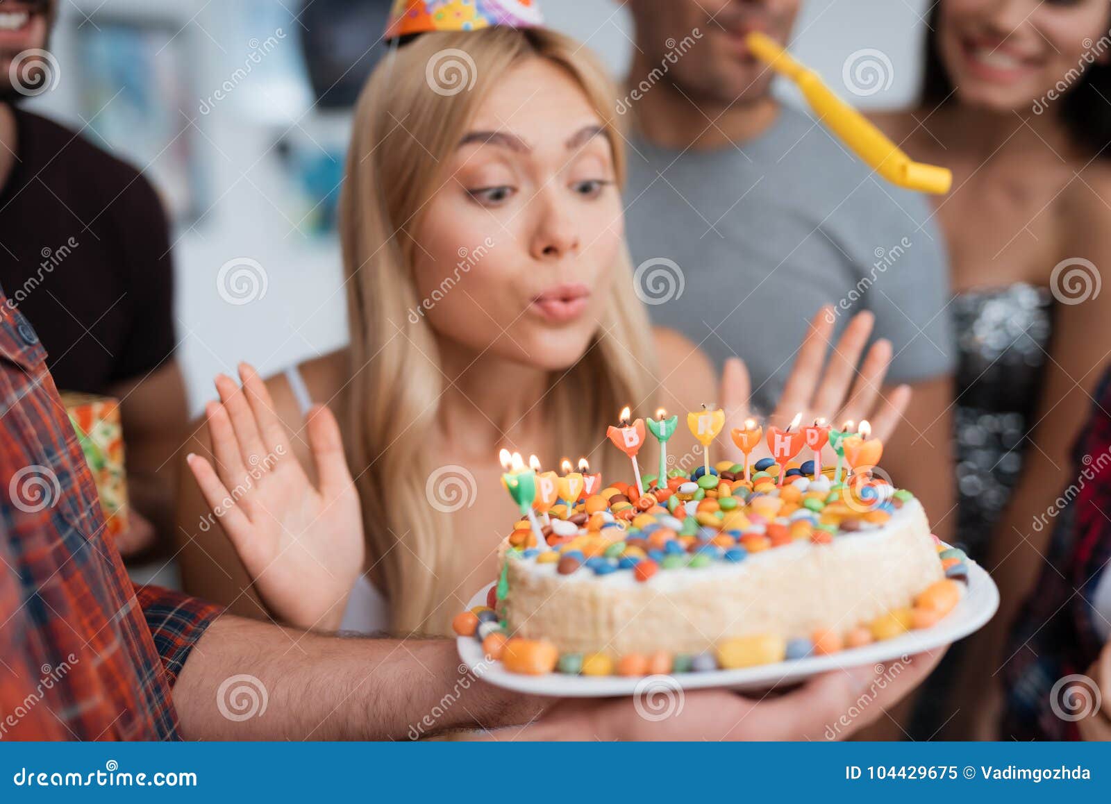 The Girl Blows Out The Candles On The Birthday Cake A Girl Blows Out