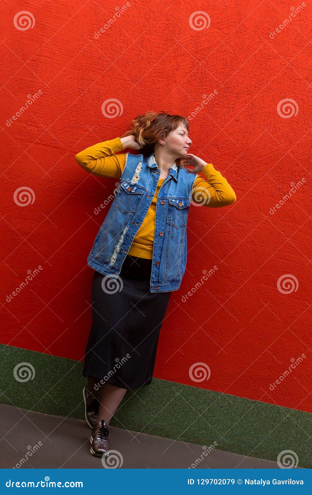 Girl in Blue Jeans at the Red Wall Stock Image - Image of blue, hair ...