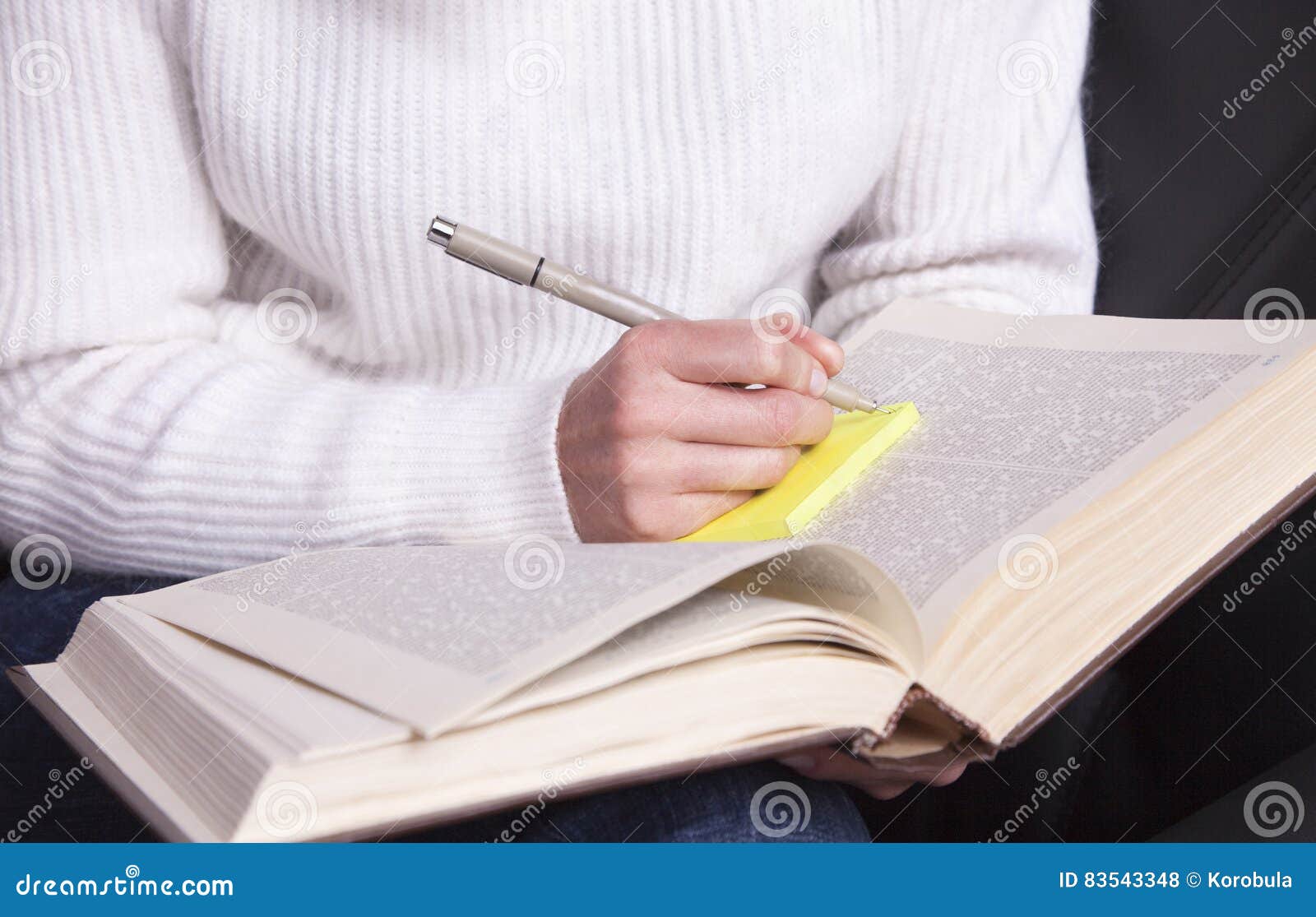 Girl with a Book in Hand Taking Notes with a Pen. Stock Photo - Image ...