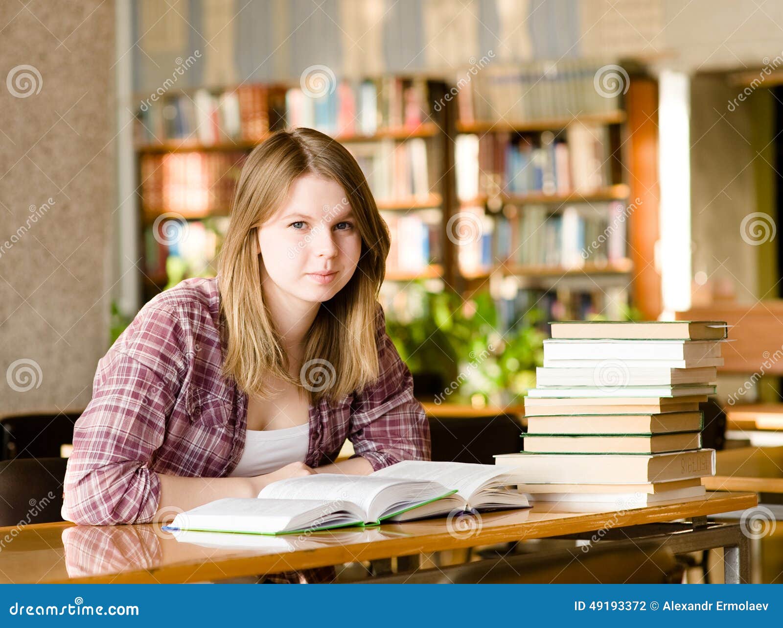 Girl with Books at the Library. Looking at Camera Stock Photo - Image ...
