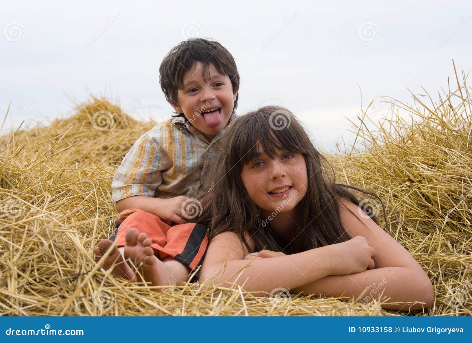 The girl and boy on hay stock photo. Image of curiosity - 10933158