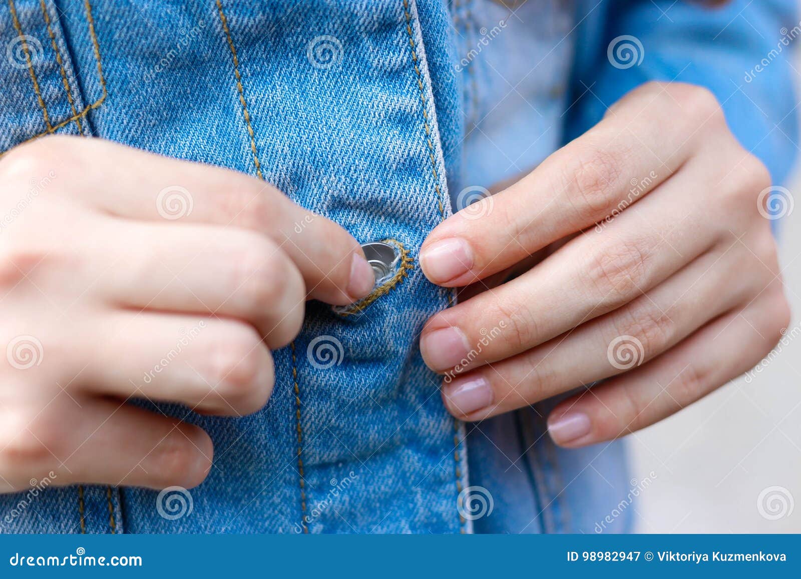 Girl Buttoning a Blue Denim Shirt. Closeup Stock Image - Image of ...