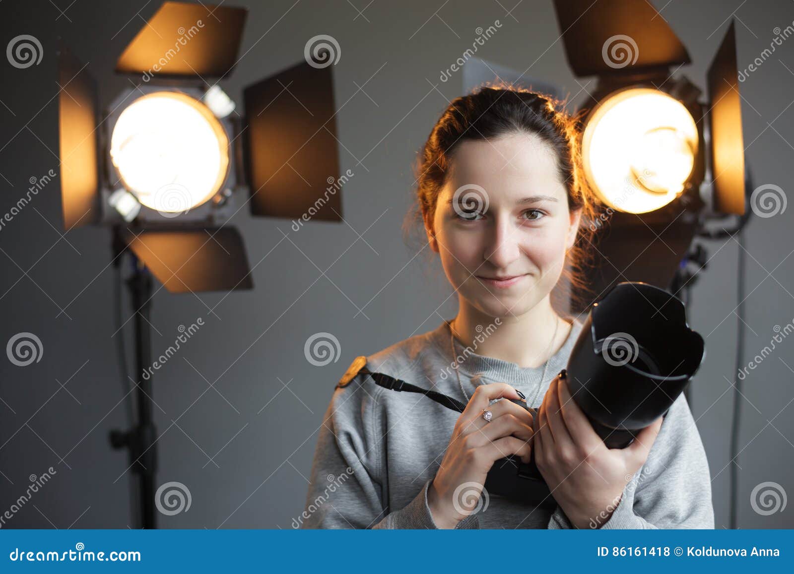 Girl with a Camera in the Studio on the Background Lighting. Hip Stock ...