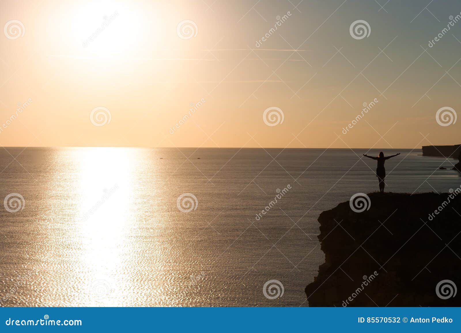 Girl on a Cliff Above the Sea at Sunset. Stock Photo - Image of outdoor ...