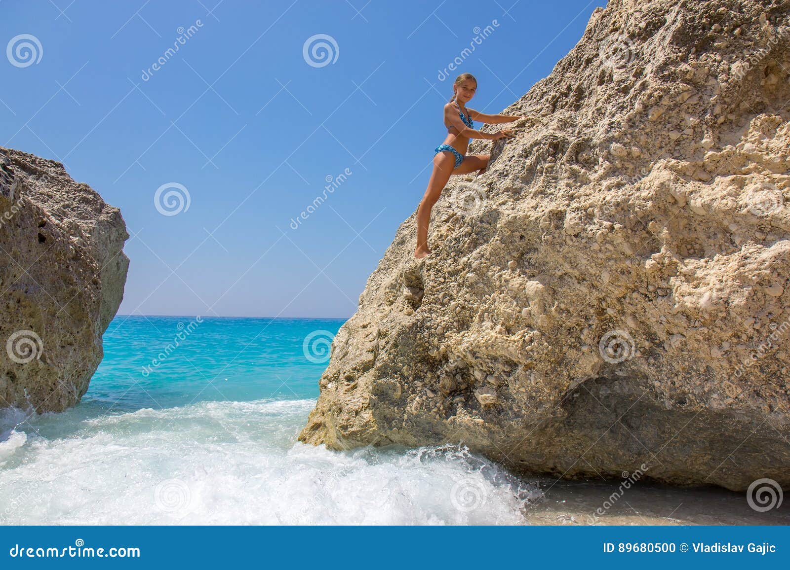 Girl Climbing on the Rock on the Beach Stock Photo - Image of happiness ...