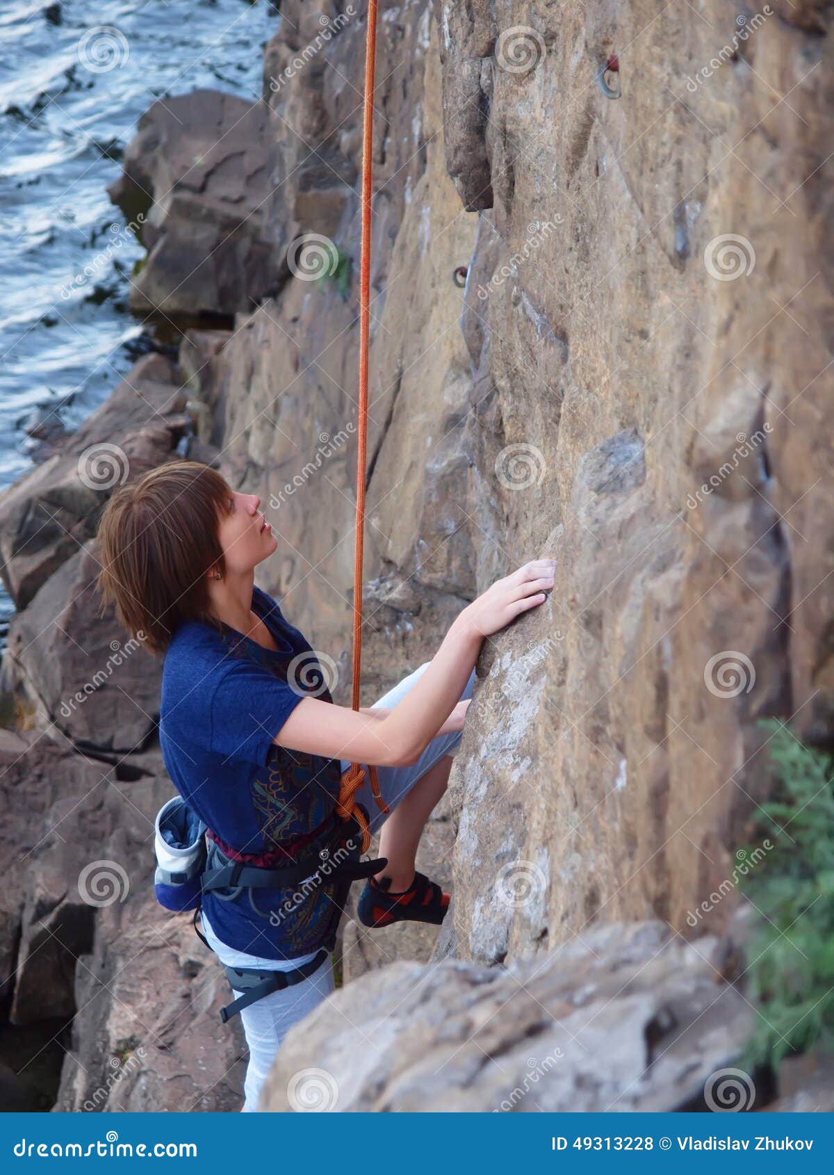 Girl climbing up a cliff. stock photo. Image of extreme - 49313228