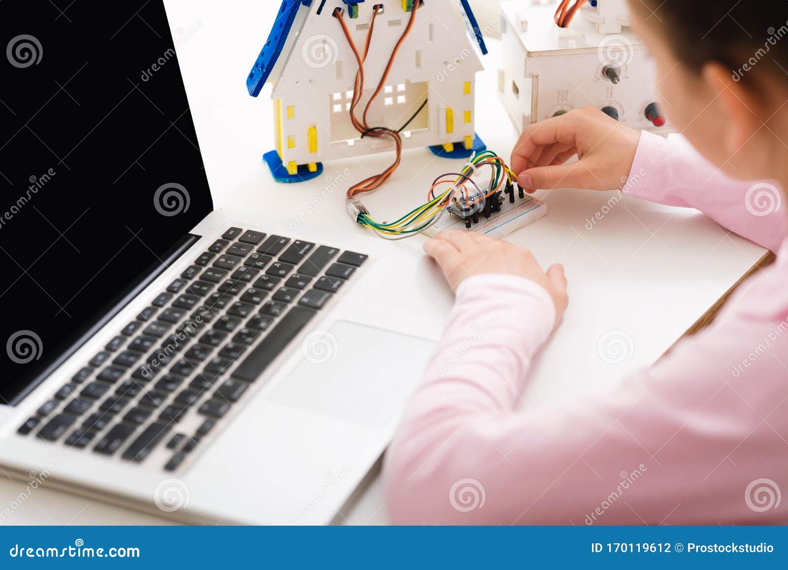 Girl Constructing Robot and Programming it on Laptop Stock Photo ...