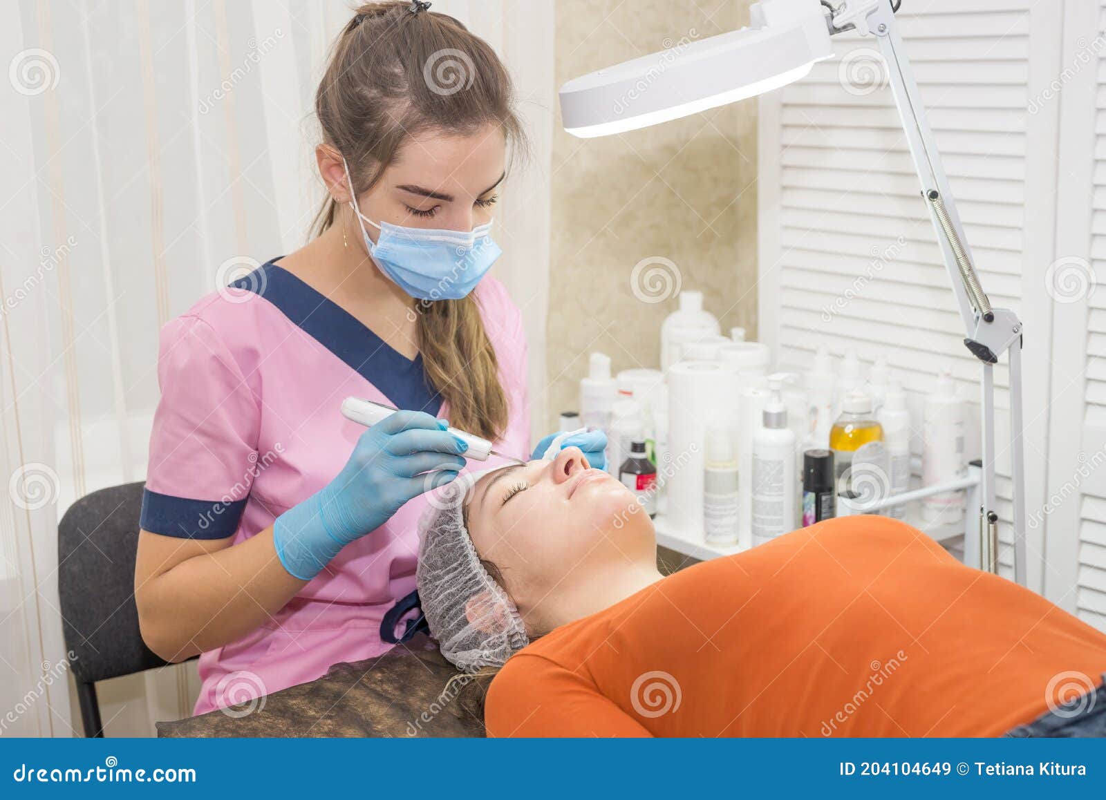 Girl Cosmetologist Makes The Procedure For Ultrasonic Face Cleaning To