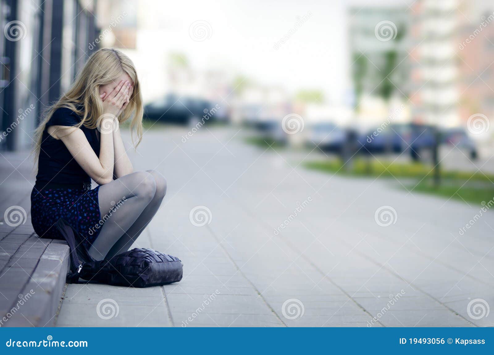 Girl Crying, Covering Face With Hands, Sitting With Legs On A Wooden ...